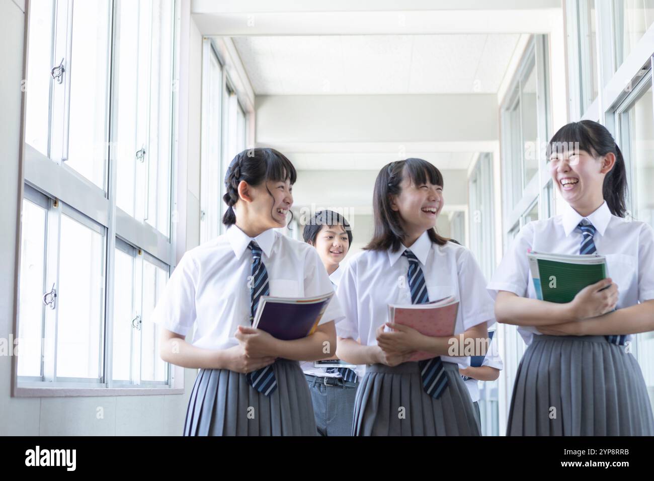 Junior high school students walking in corridor Stock Photo - Alamy