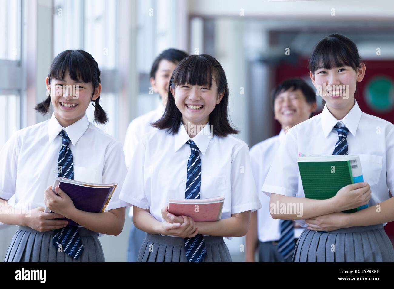 Junior high school students walking in corridor Stock Photo - Alamy