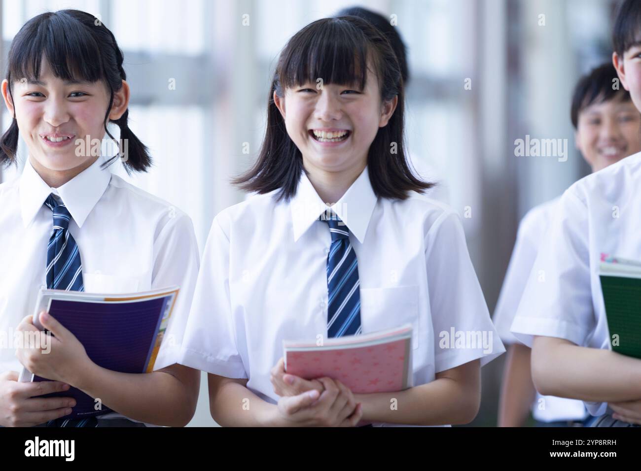 Junior high school students walking in corridor Stock Photo - Alamy