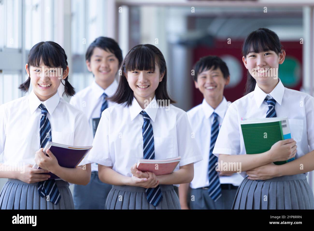 Junior high school students walking in corridor Stock Photo - Alamy