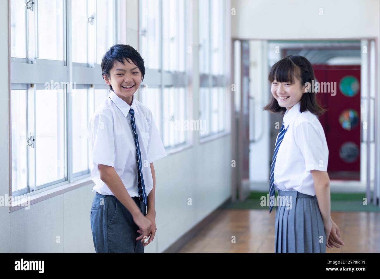 Junior high school students standing in line in corridor Stock Photo ...