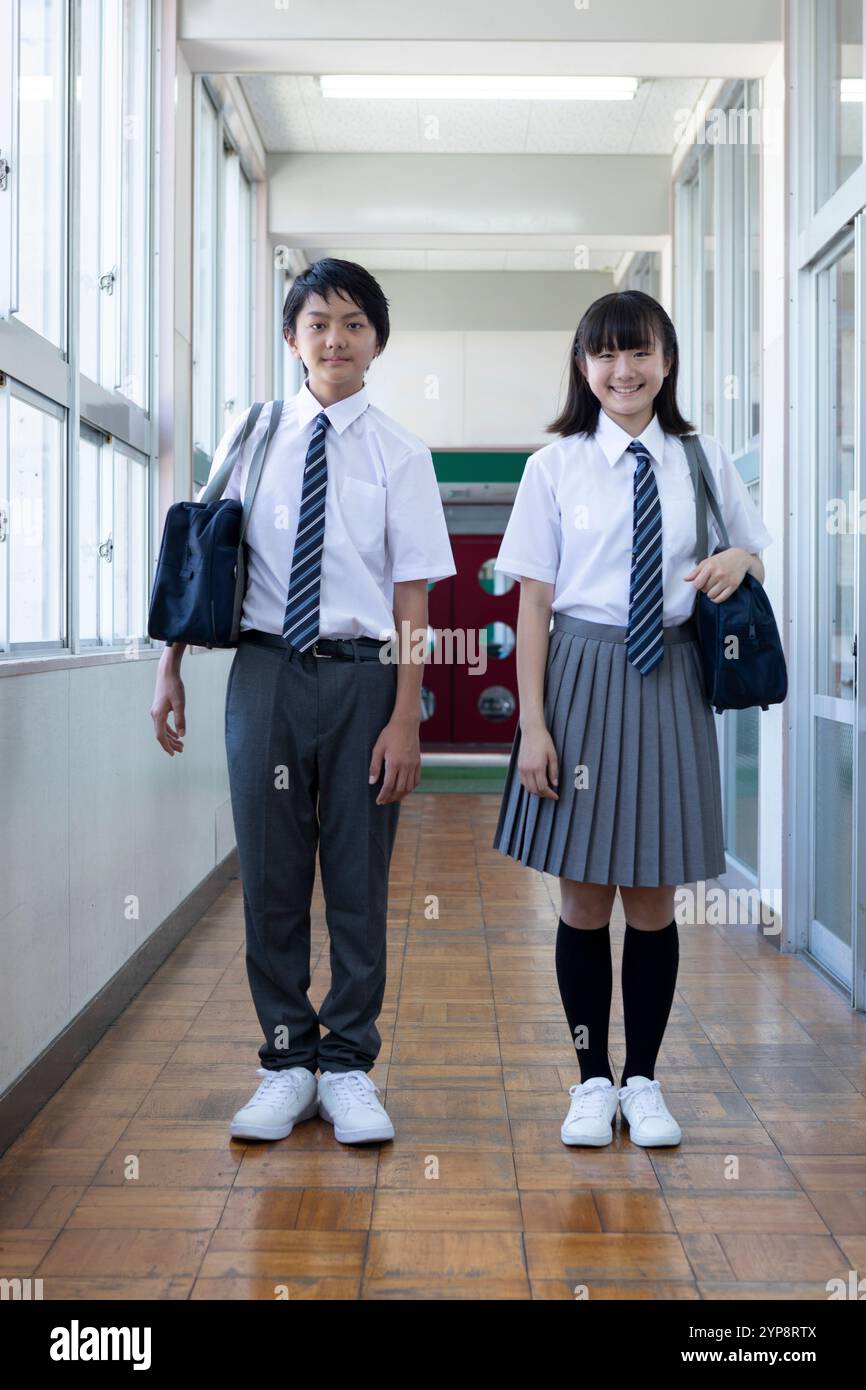 Junior high school students standing in line in corridor Stock Photo ...