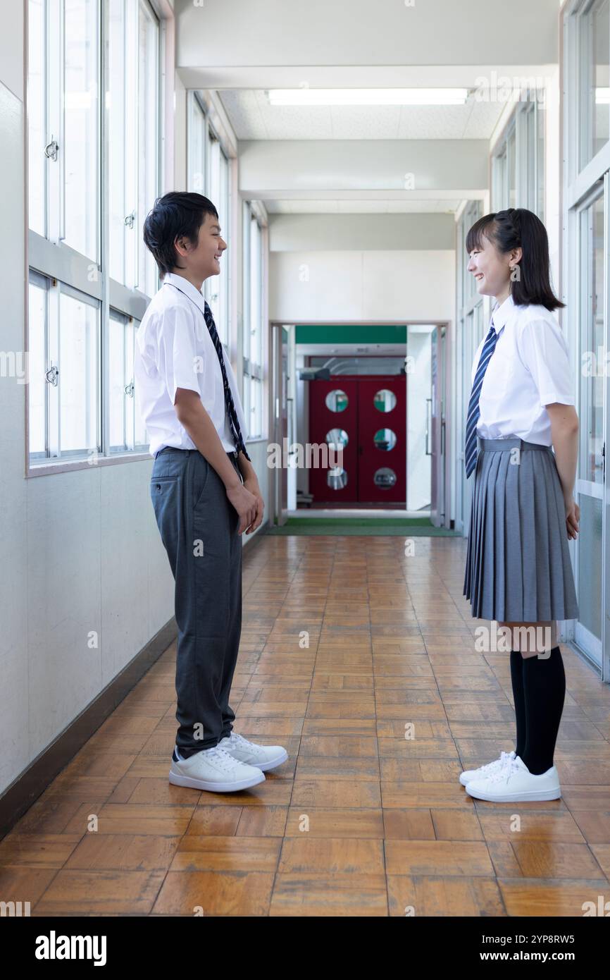 Junior high school students standing in line in corridor Stock Photo ...