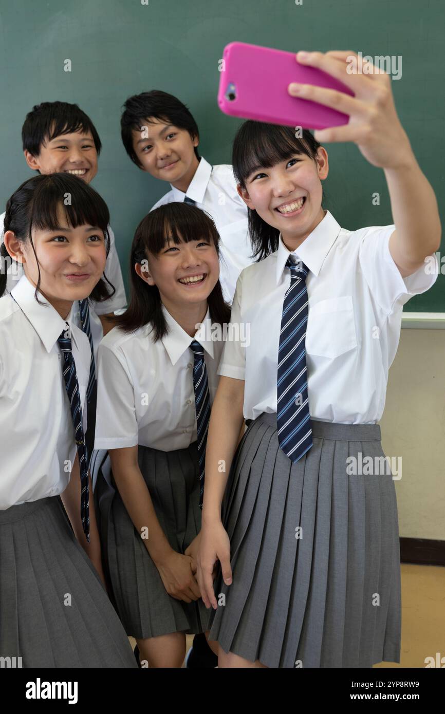 Secondary school student taking a photo with a selfie Stock Photo - Alamy