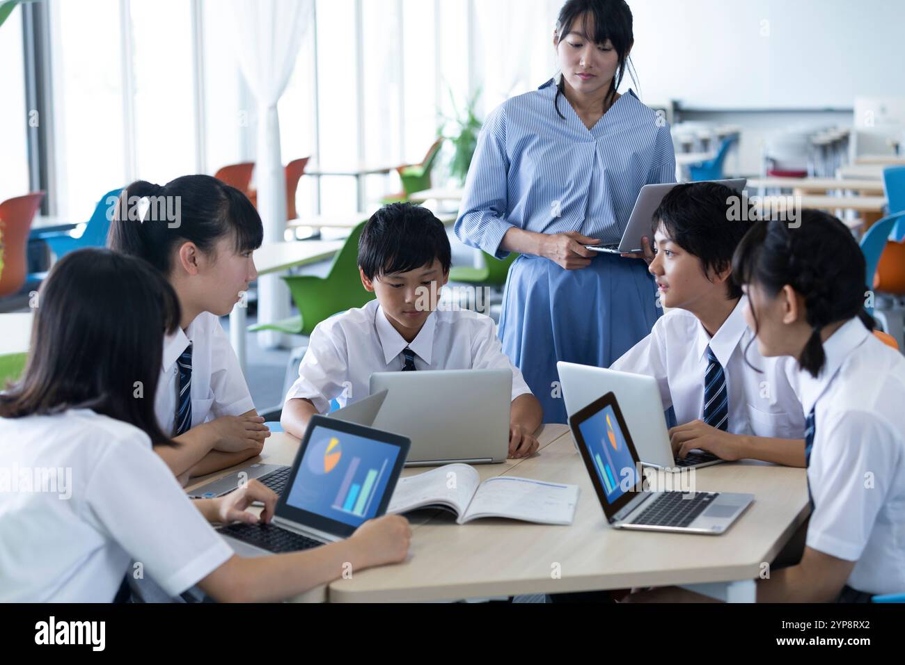 Junior high school students doing group work Stock Photo - Alamy