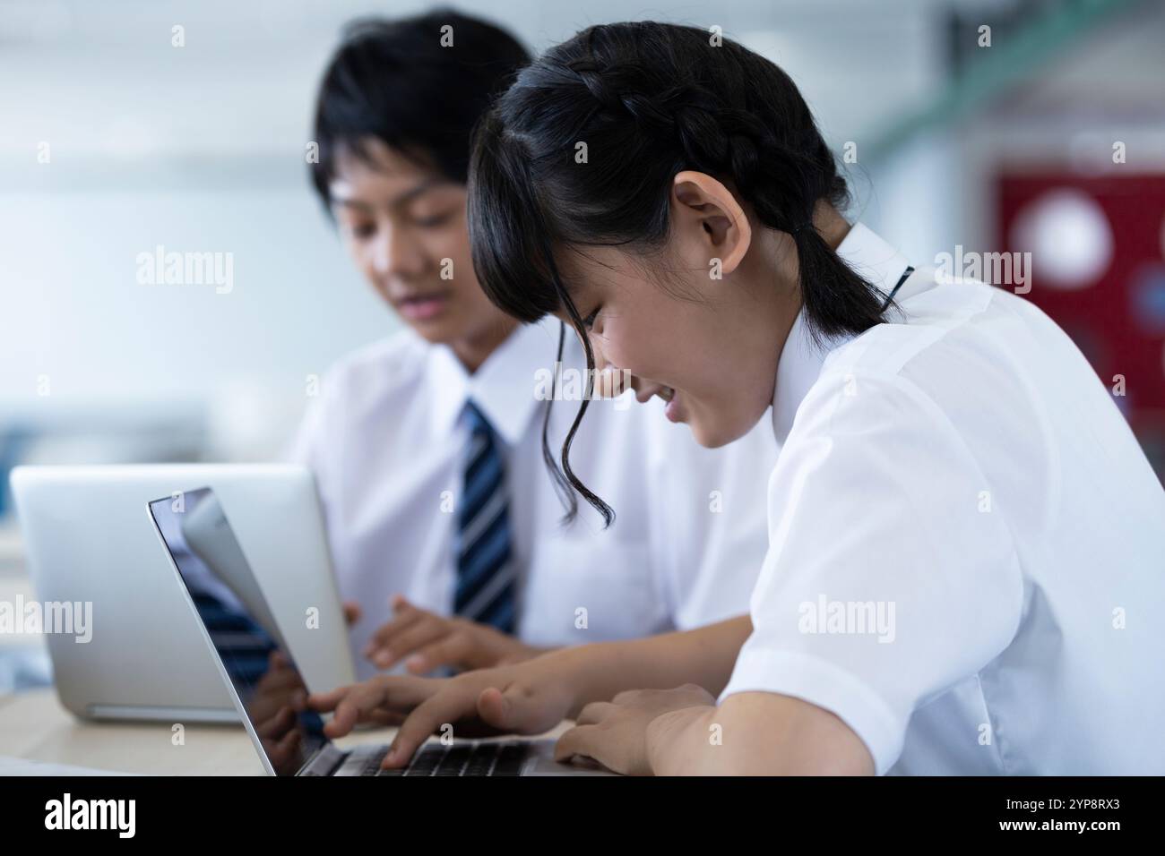 Junior high school students doing group work Stock Photo - Alamy