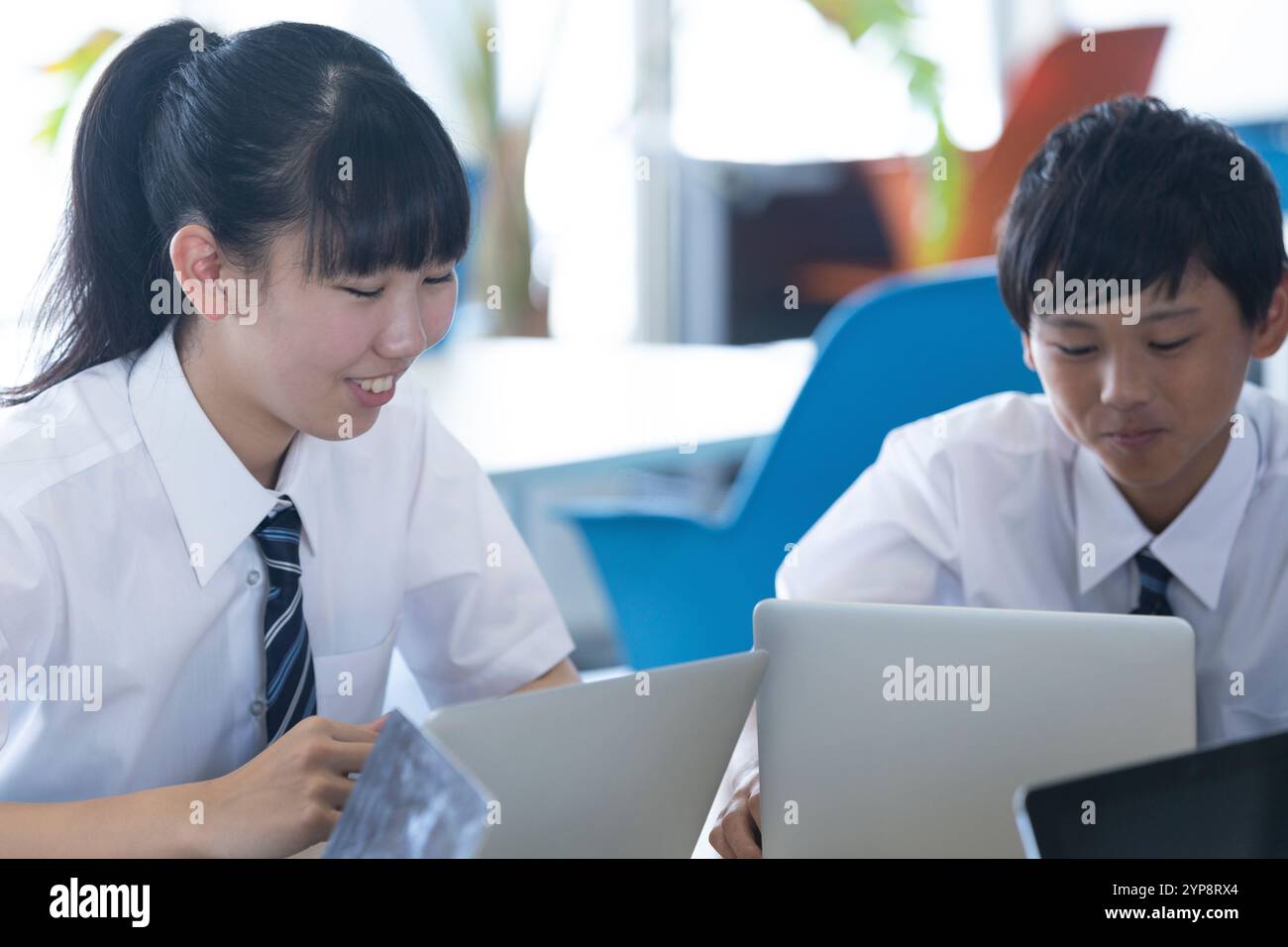 Junior high school students doing group work Stock Photo - Alamy