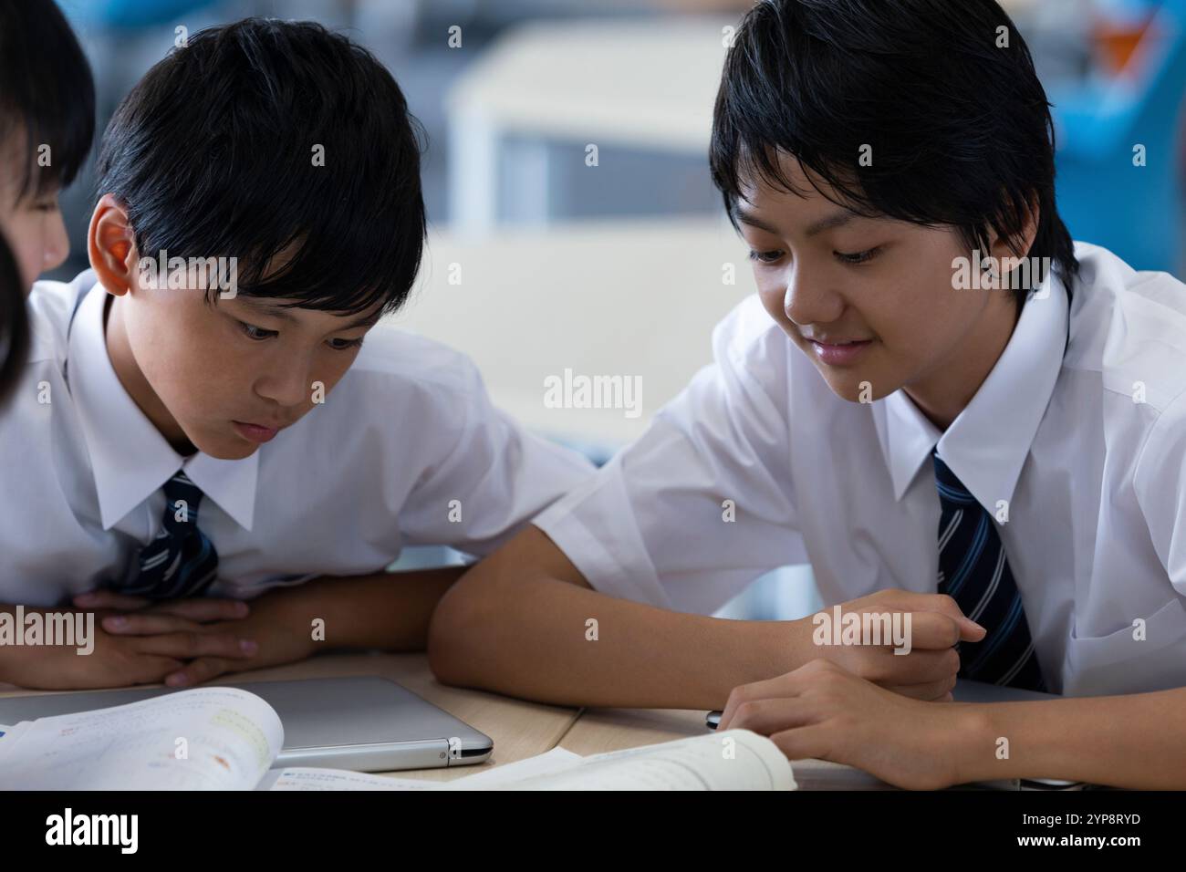 Junior high school students doing group work Stock Photo - Alamy