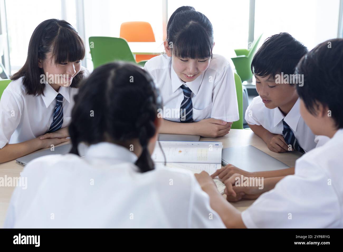 Junior high school students doing group work Stock Photo - Alamy