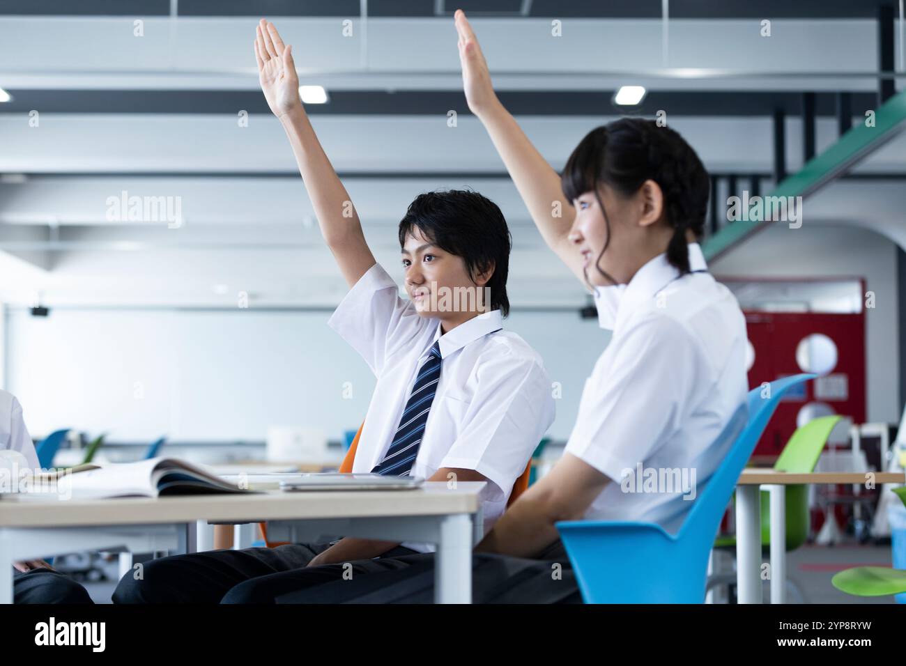 Junior high school students doing group work Stock Photo - Alamy