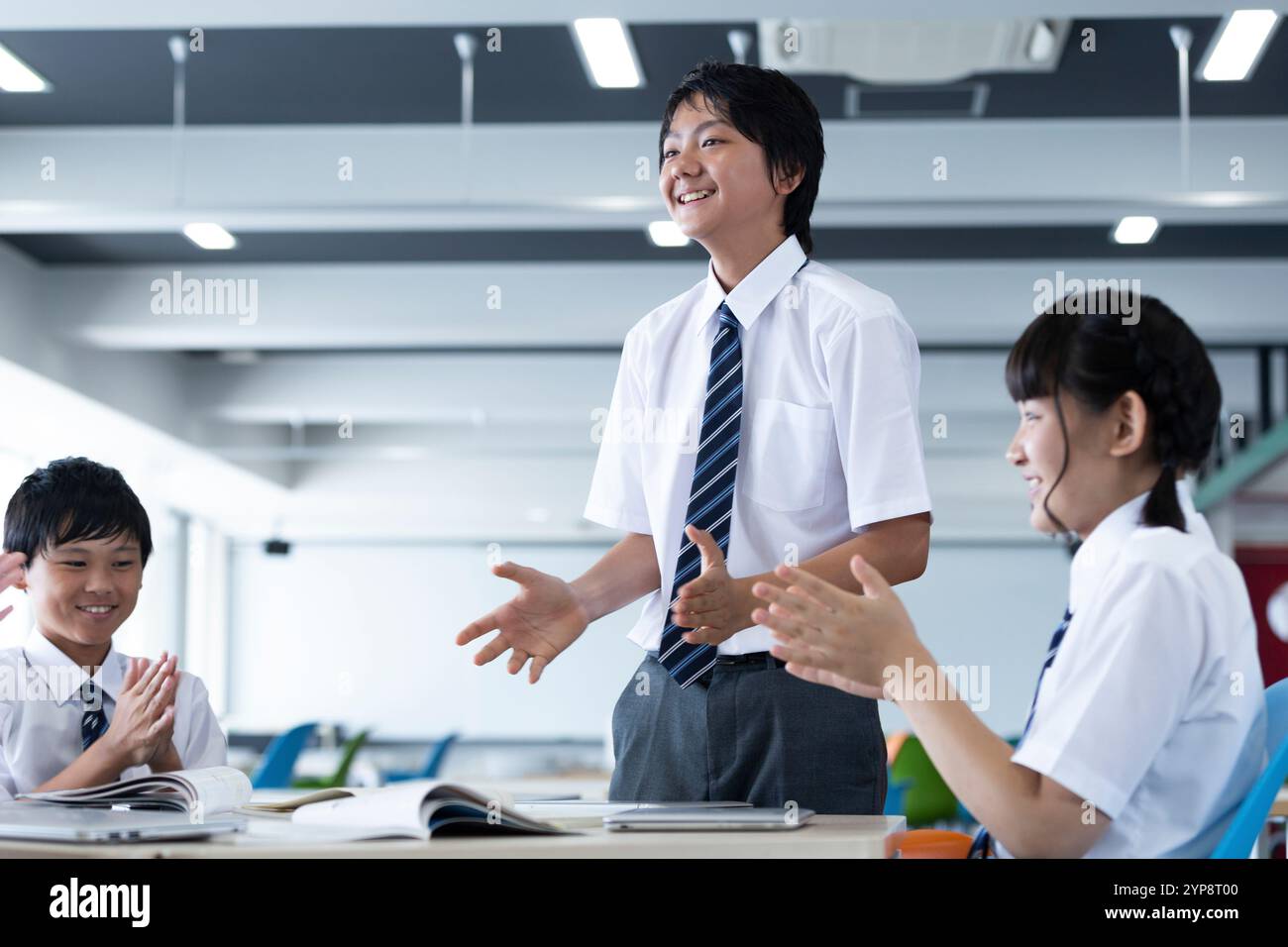 Junior high school students doing group work Stock Photo - Alamy