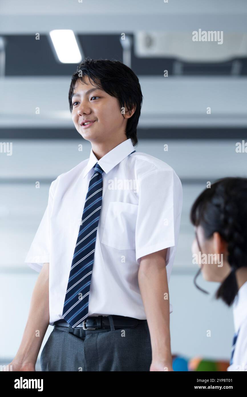 Junior high school students doing group work Stock Photo - Alamy