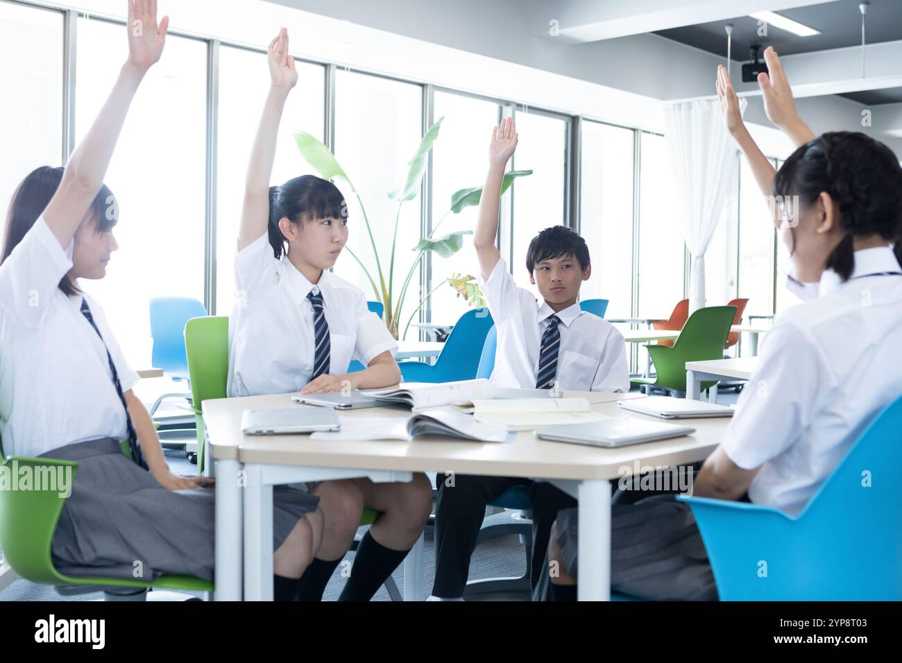 Junior high school students doing group work Stock Photo - Alamy
