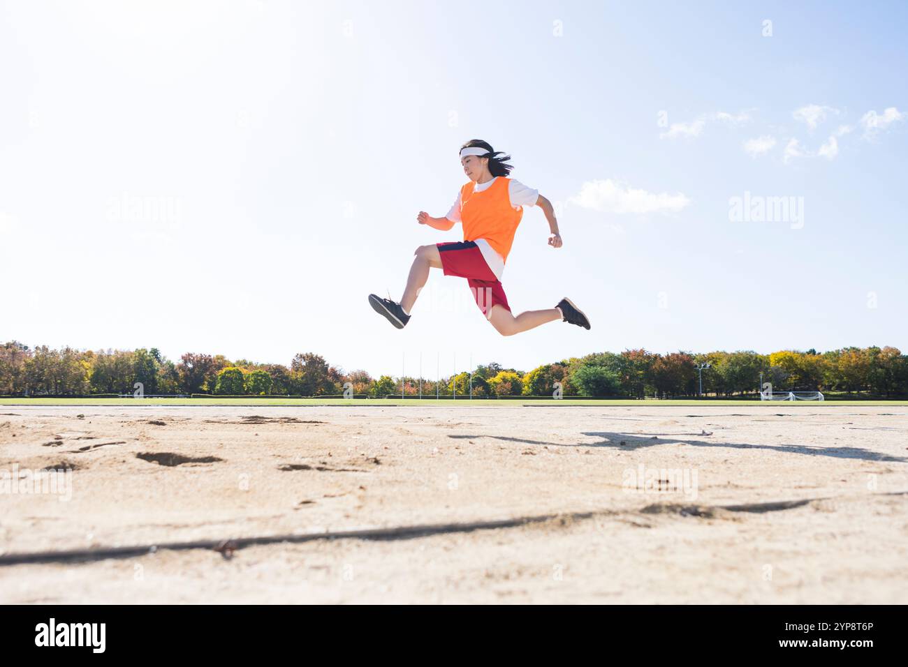 High school students doing the long jump Stock Photo - Alamy
