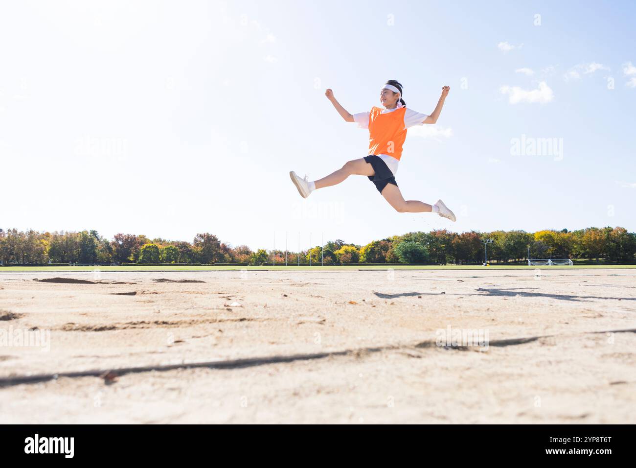 High school students doing the long jump Stock Photo - Alamy