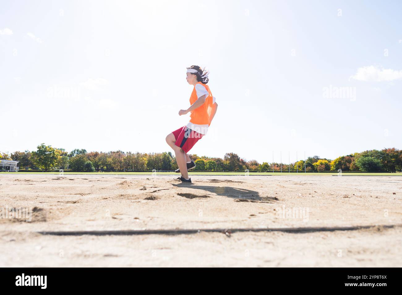High school students doing the long jump Stock Photo - Alamy