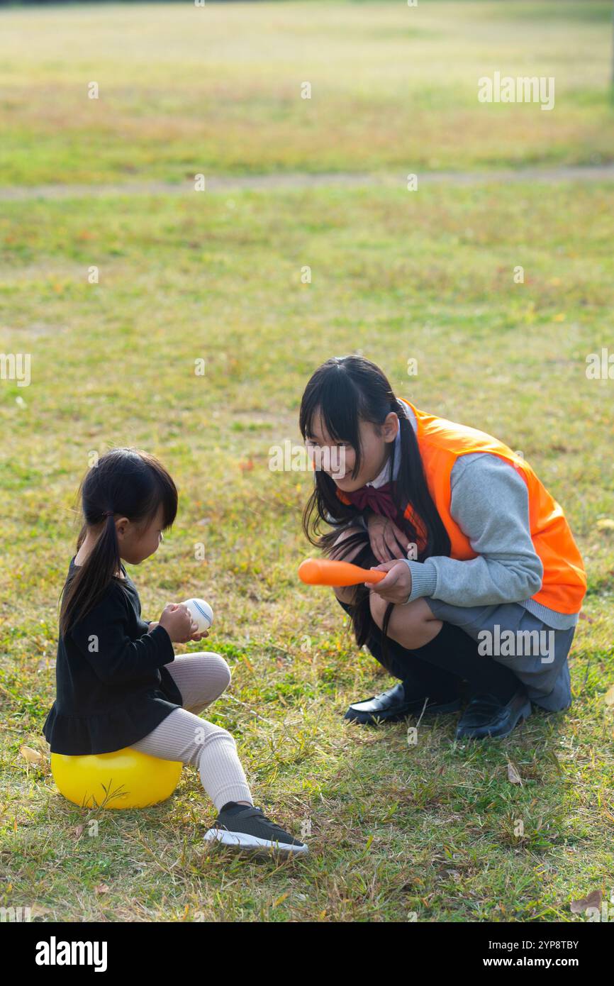High school students playing with children Stock Photo - Alamy
