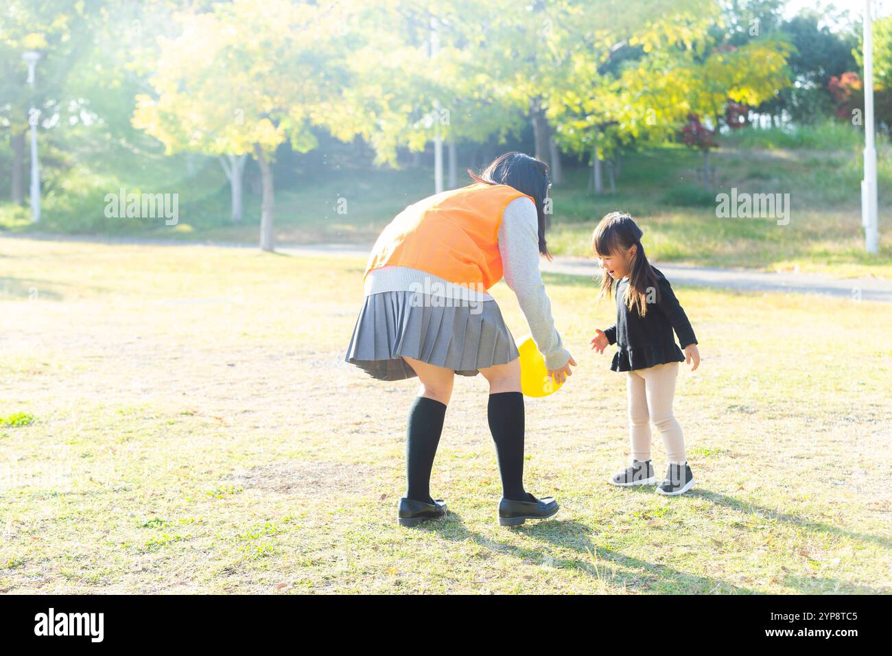 High school student playing with child Stock Photo - Alamy