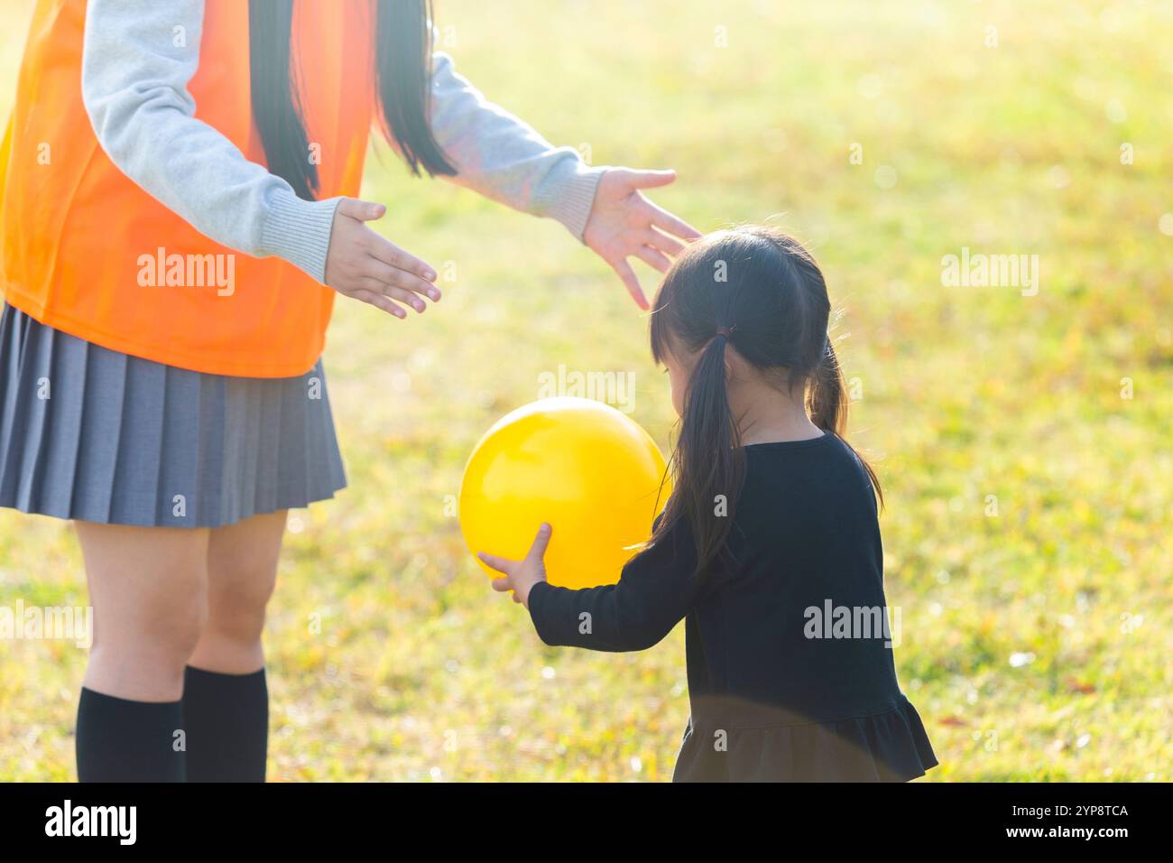 High school student playing with child Stock Photo - Alamy