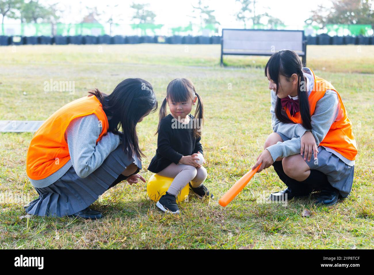 High school student playing with child Stock Photo - Alamy
