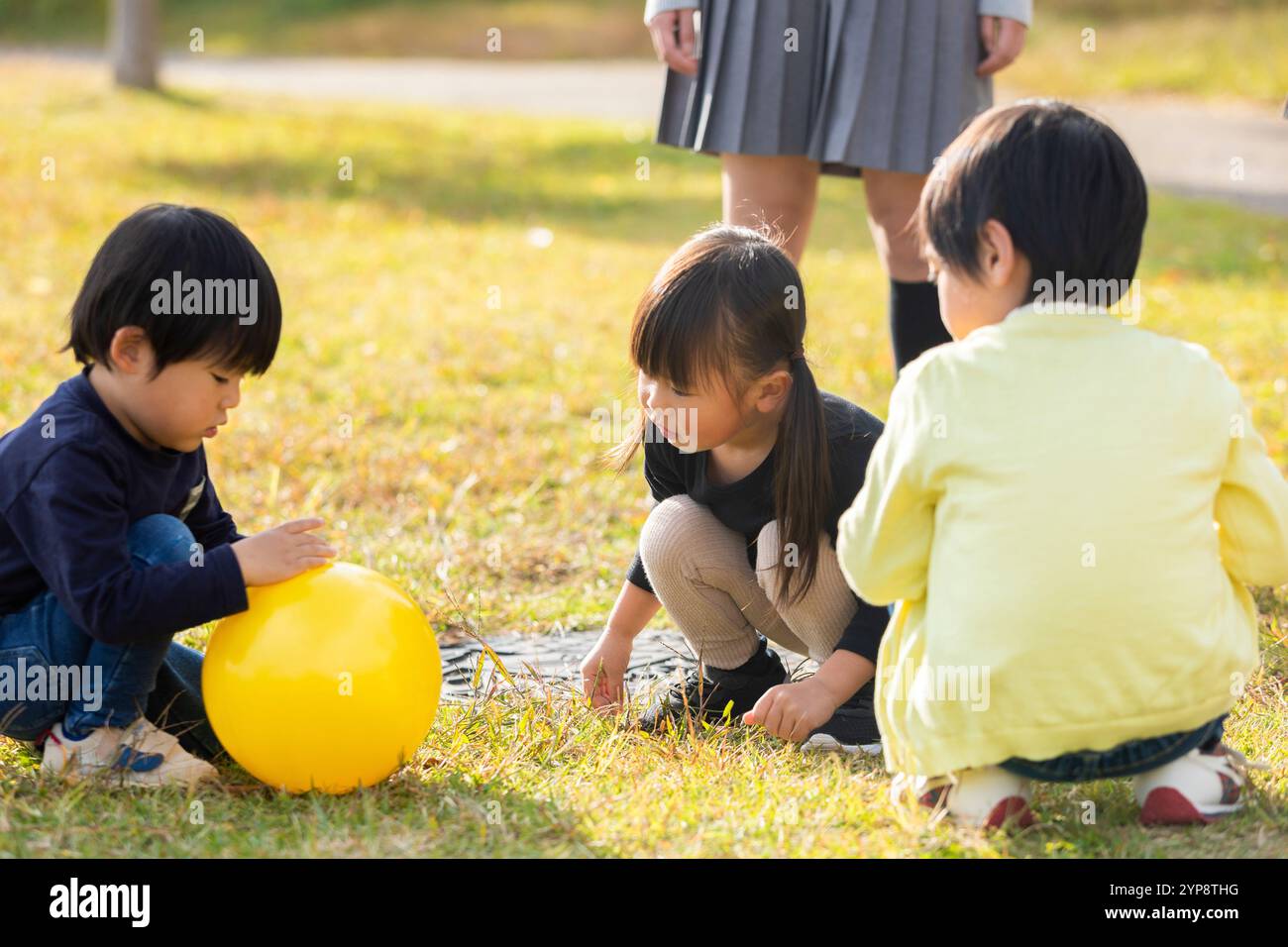 Three children playing ball hi-res stock photography and images - Alamy