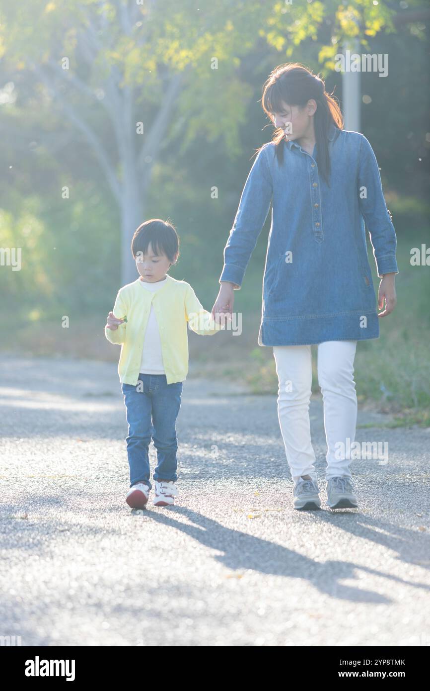 Parent and child taking a walk Stock Photo - Alamy