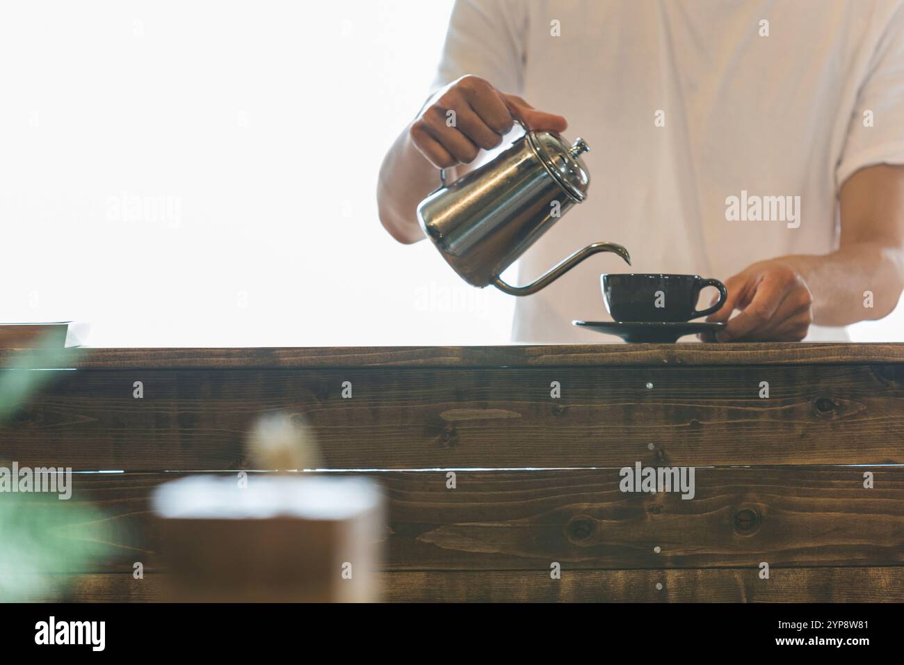 Hand pouring coffee Stock Photo - Alamy