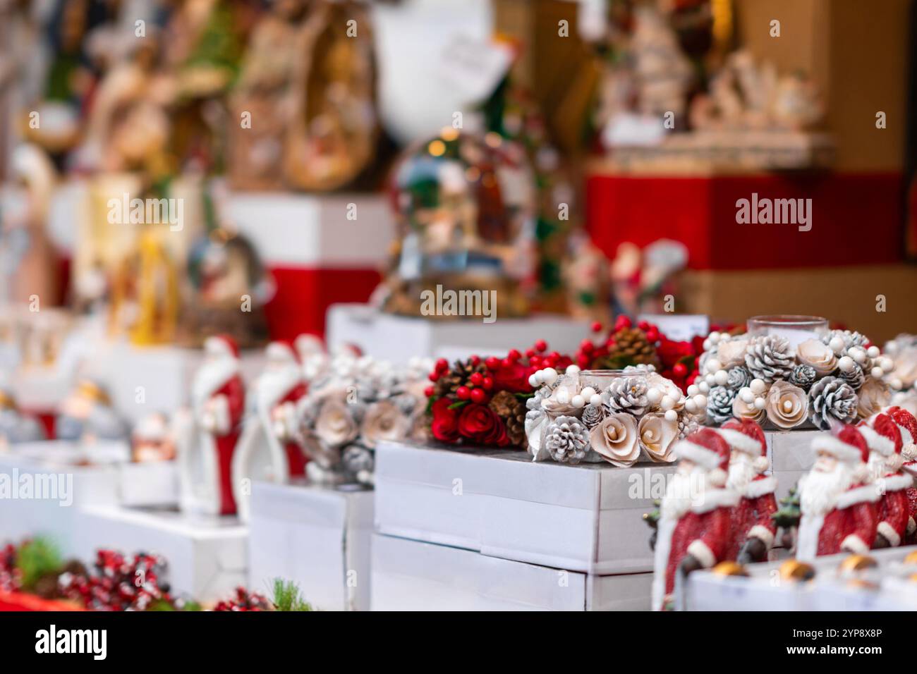 Christmas market stall filled with wreaths, Santa figurines and other ...