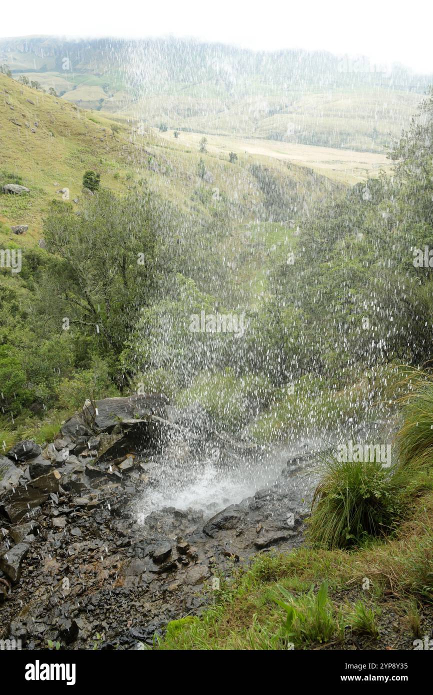 Curtain of water droplets falling on wet rocks, waterfall in Kamberg ...