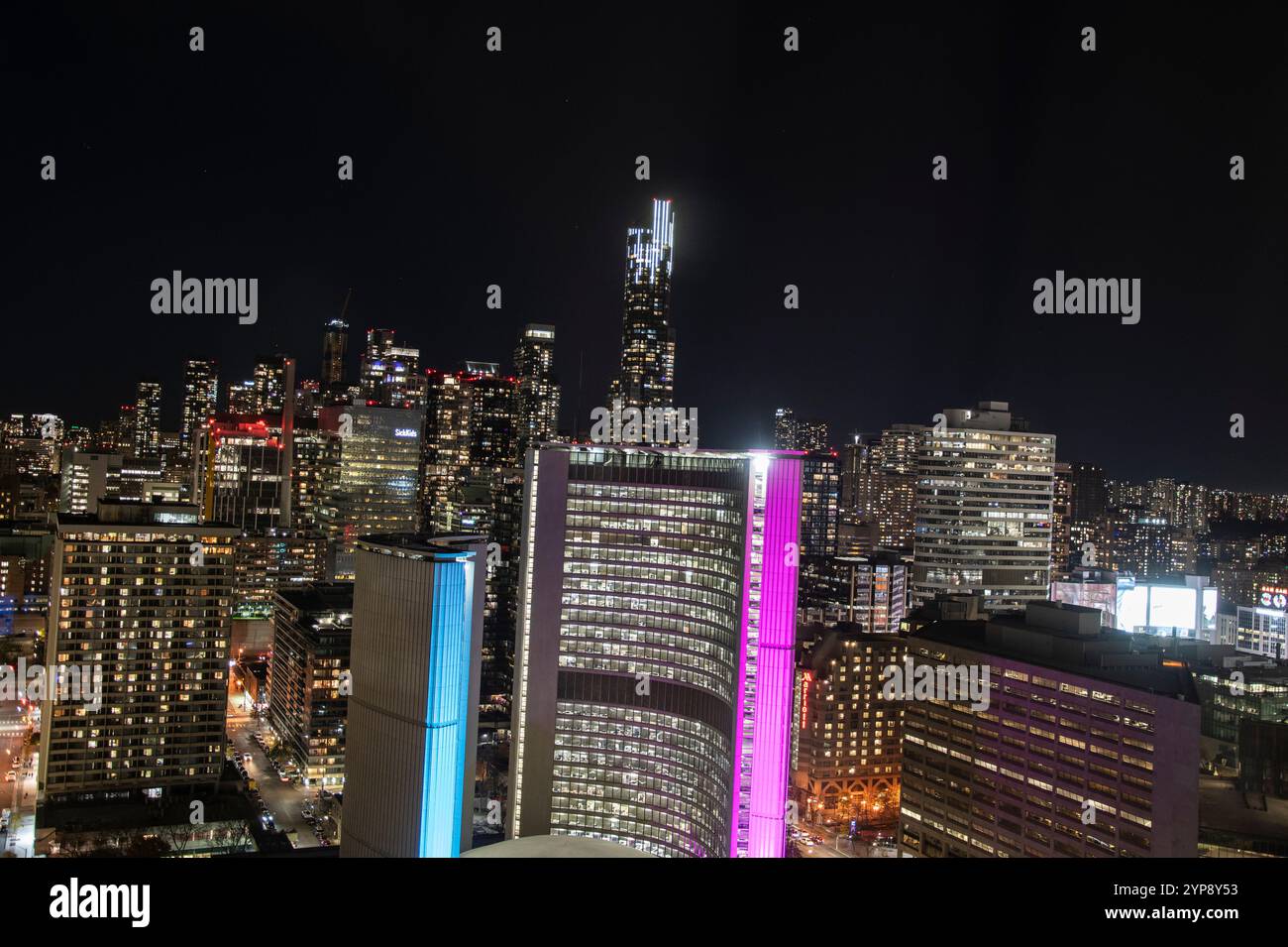 Changing color lights on city hall twin towers at night on Queen Street ...