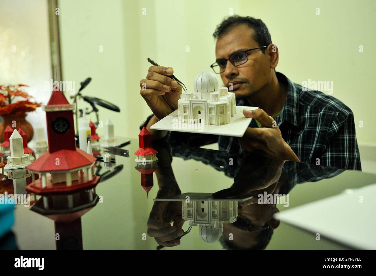 Sylhet, Bangladesh. 28th Nov, 2024. An artist manufacturing scale models of Sworld's heritage ...