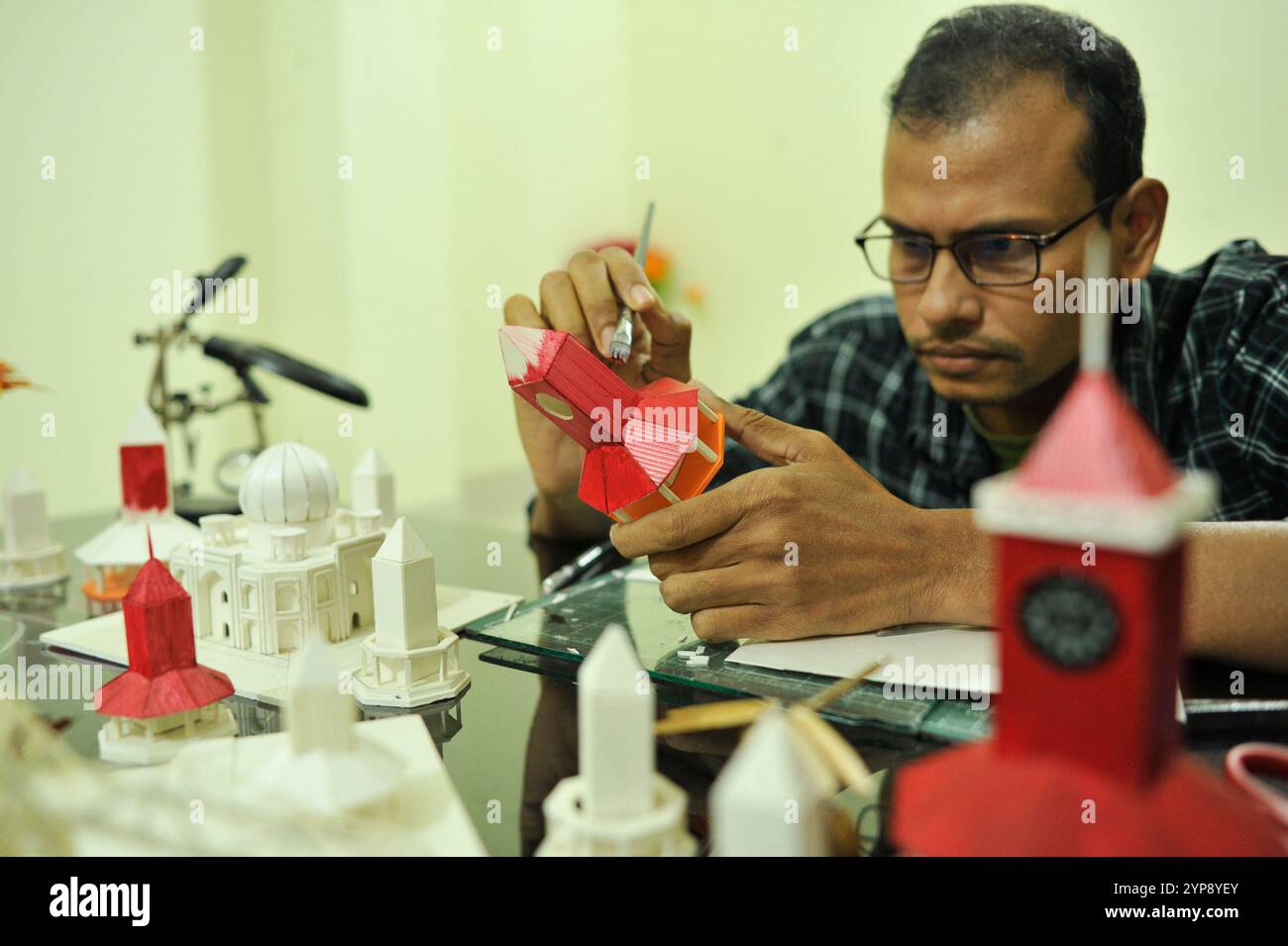 Sylhet, Bangladesh. 28th Nov, 2024. An artist manufacturing scale models of Sylhet's Historic ...