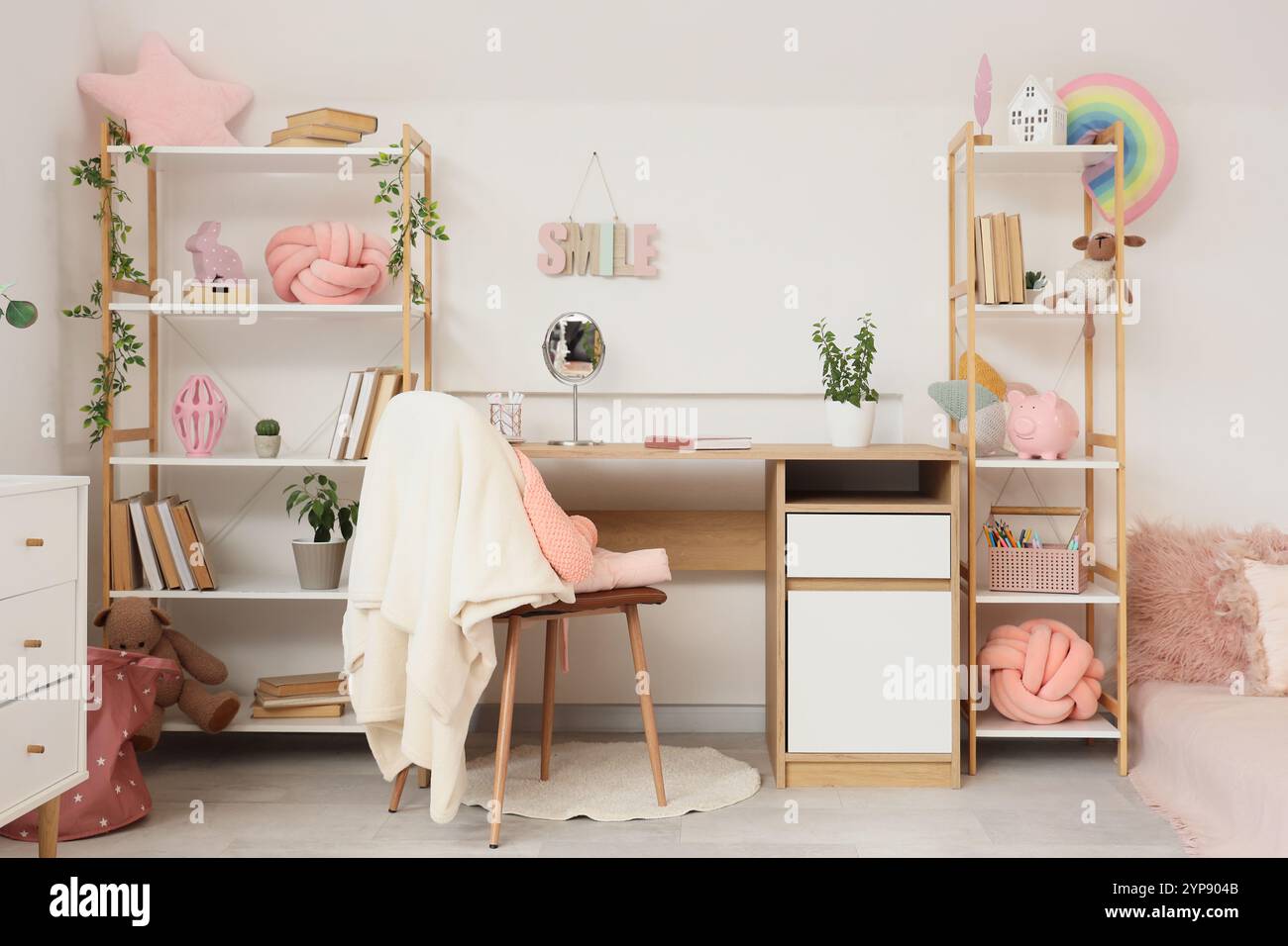 Interior of children's room with study table, toys and shelf units ...