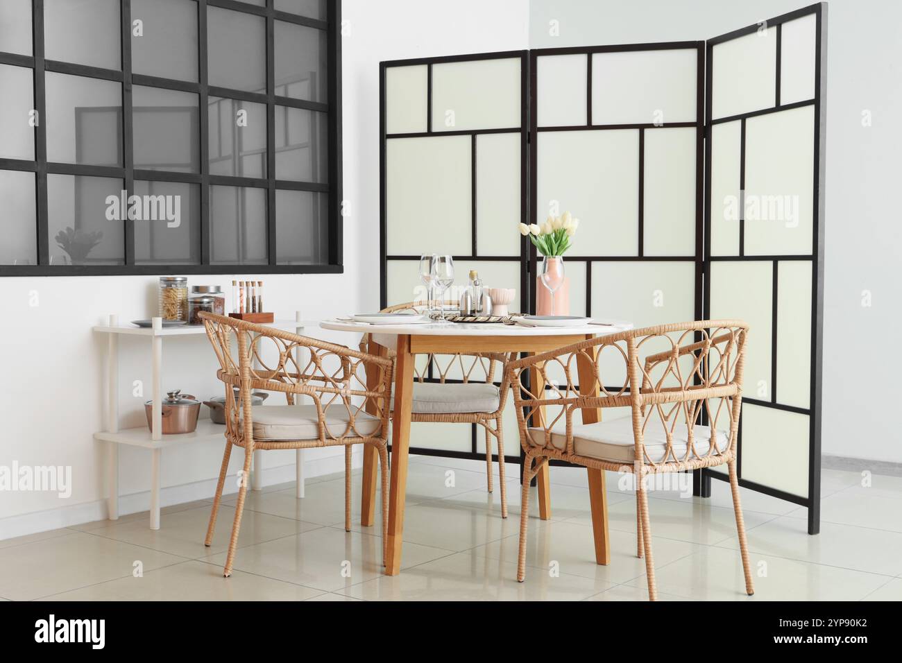Interior of room with folding screen, shelf unit and dining table Stock ...