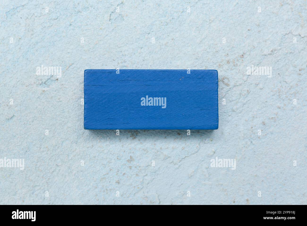 Blue block on light grunge background. Rules concept Stock Photo - Alamy
