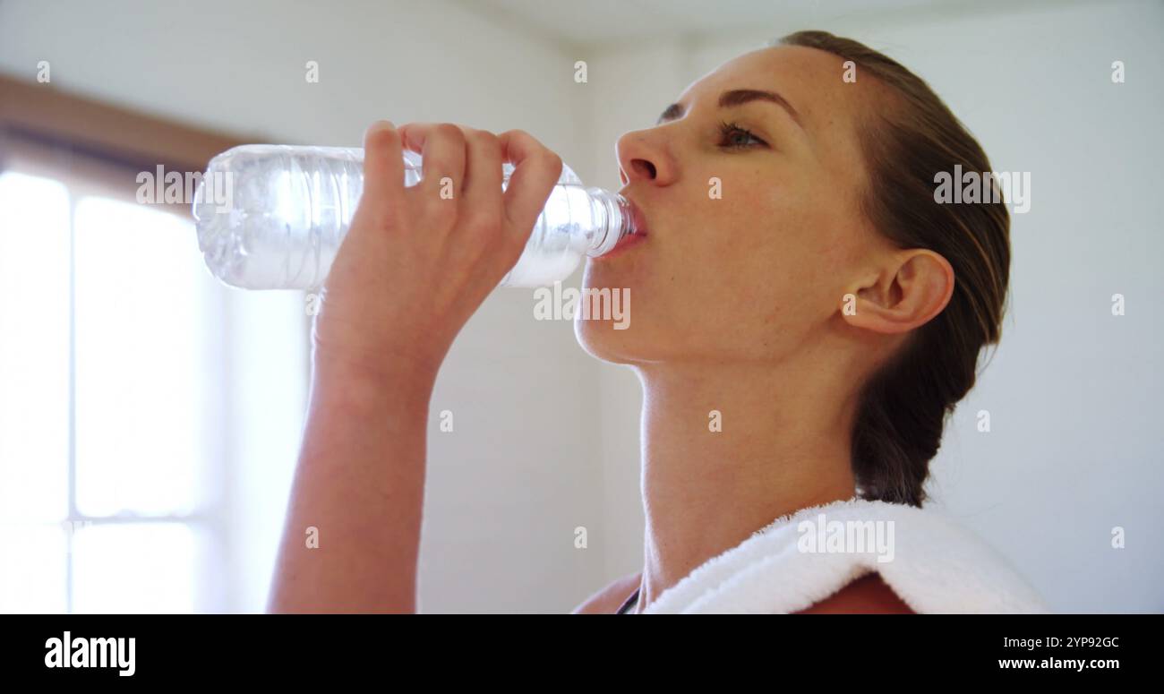 Close-up of woman drinking water in the gym 4k Stock Photo - Alamy