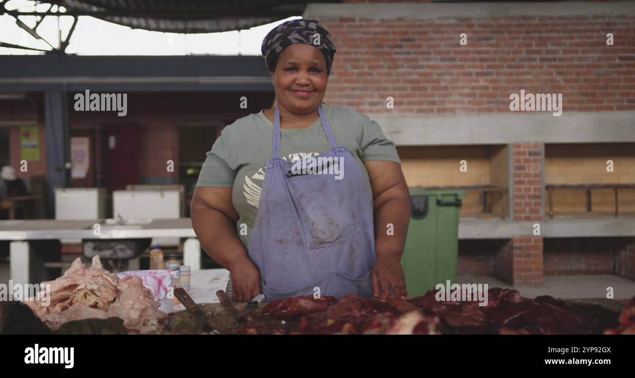 Happy female butcher standing hi-res stock photography and images - Alamy