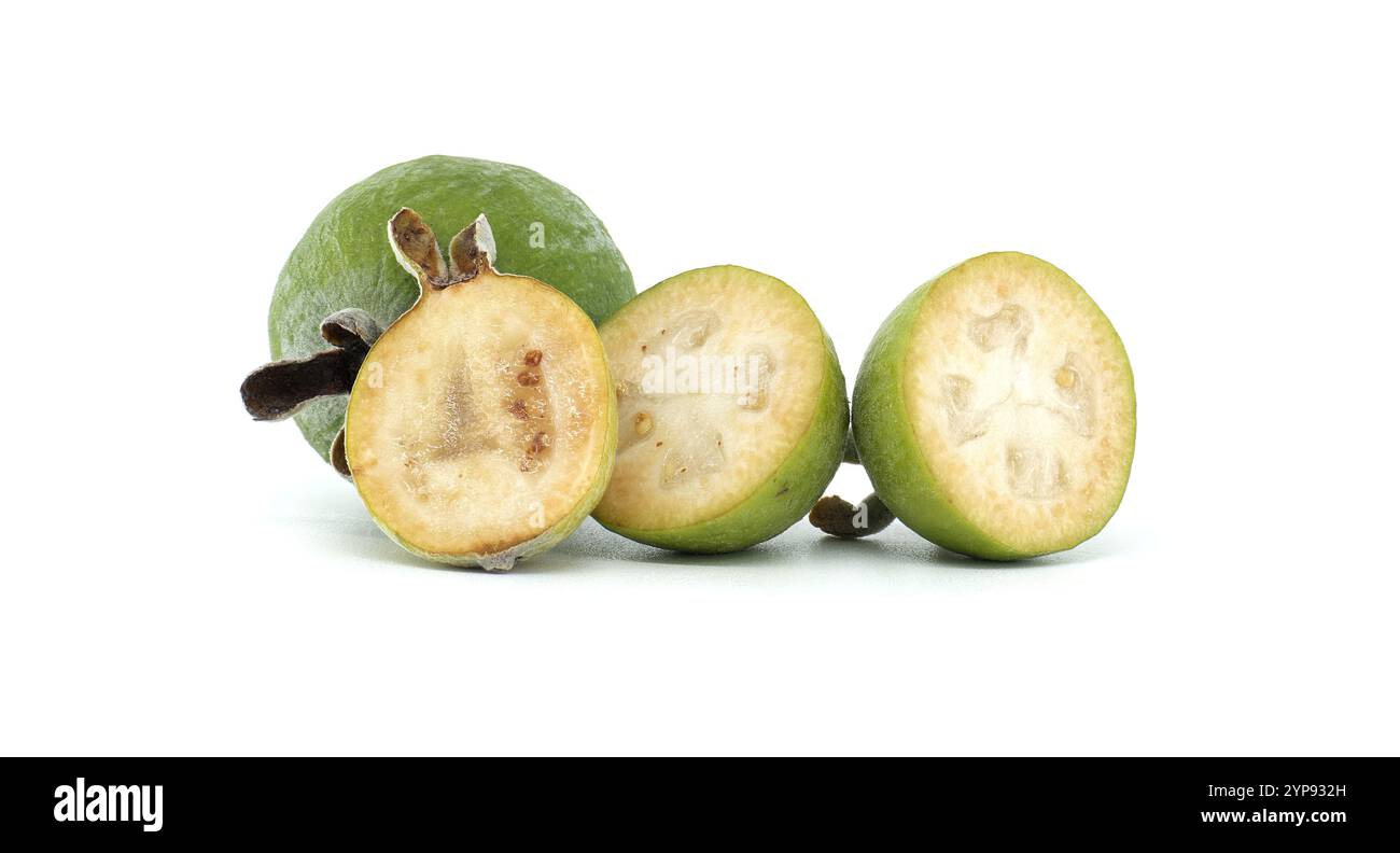 A close-up image of fresh, green feijoa fruits, including both whole ...