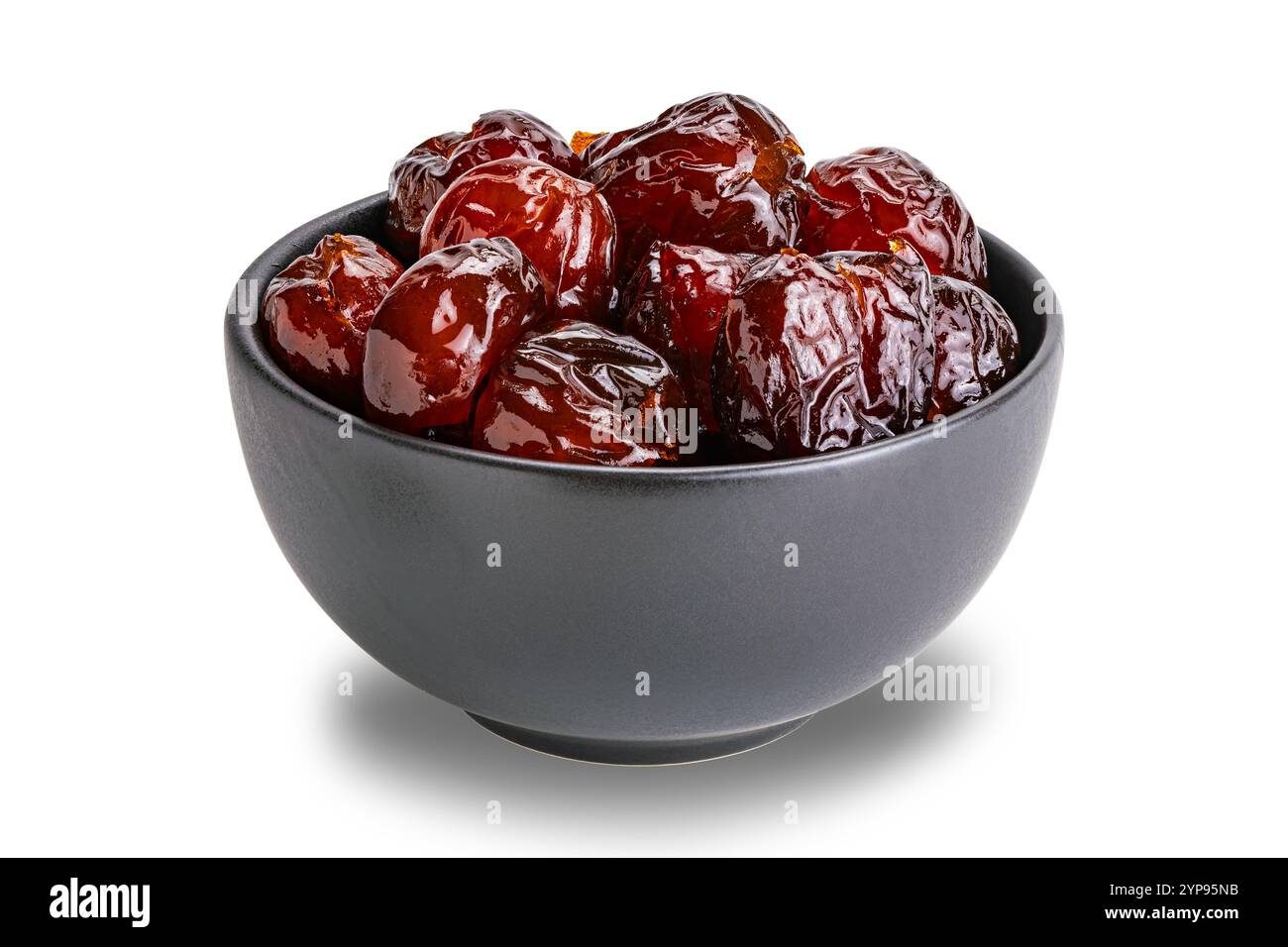 Pile of sweet pitted chinese jujube fruit preserved in syrup in black ...