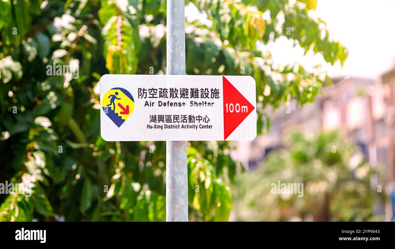 Air defense shelter sign in Taiwan, situated among urban greenery ...