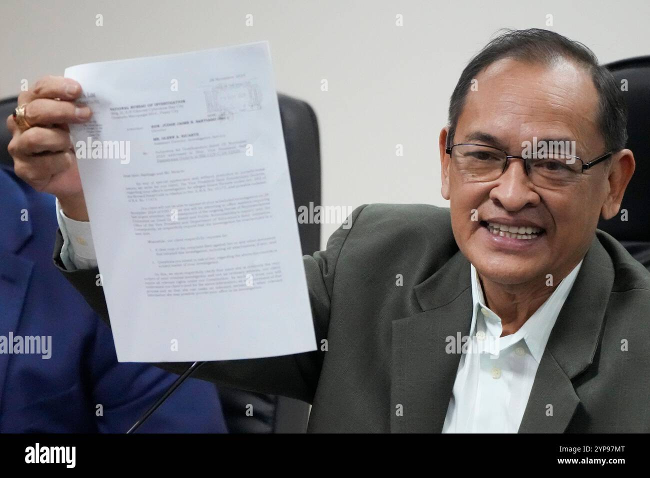 National Bureau of Investigation Director Jaime Santiago holds a copy ...