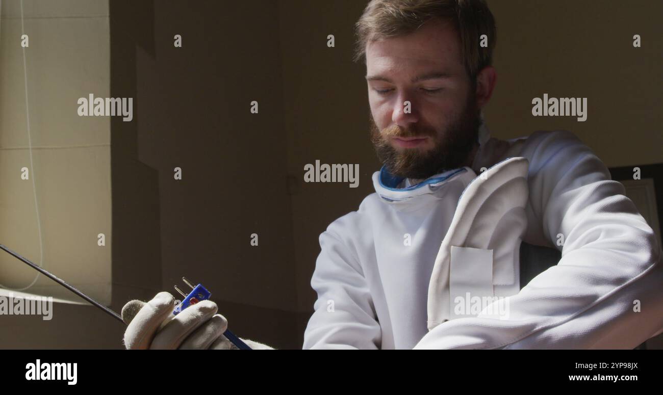 Low angle front view of a confident focused Caucasian male fencer ...