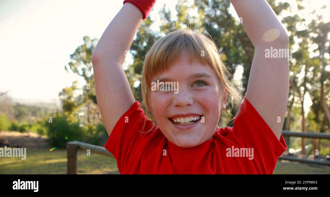 Happy girl cheering in boot camp during obstacle course Stock Photo - Alamy