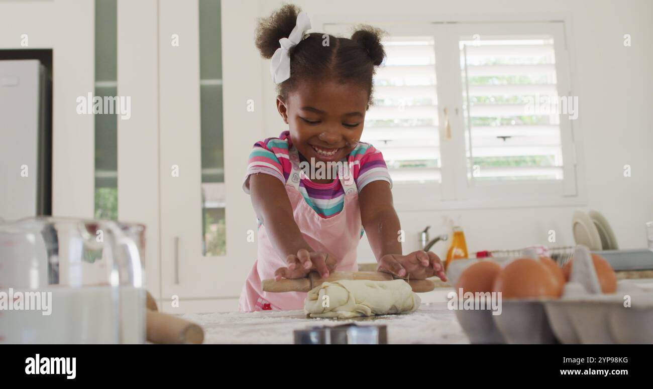 Happy african american girl rolling dough in kitchen Stock Photo - Alamy