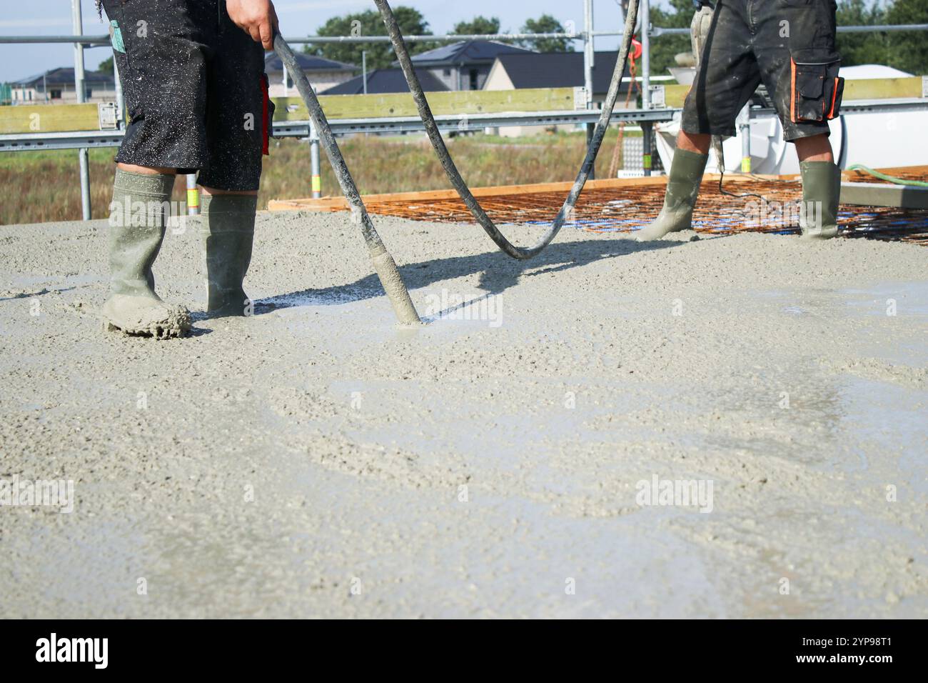 Workers filling the second floor ground with concrete, core and shell ...