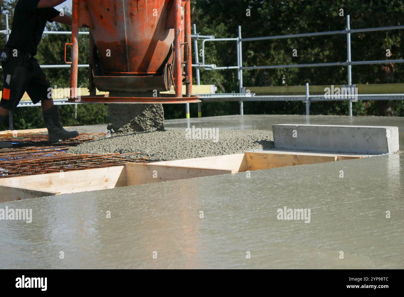 Workers filling the second floor ground with concrete, core and shell ...