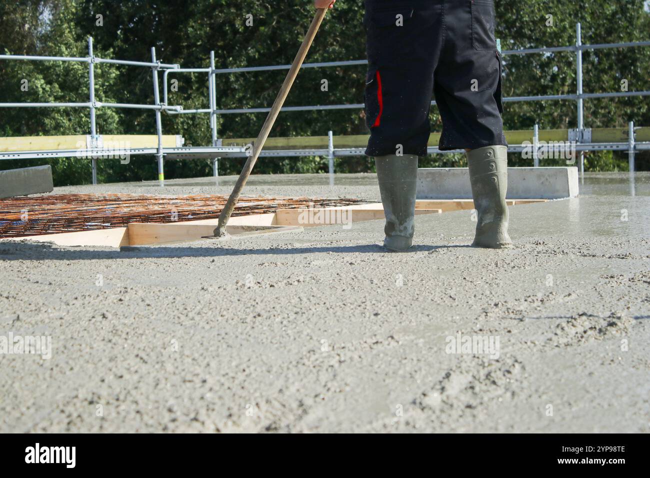 Workers filling the second floor ground with concrete, core and shell ...