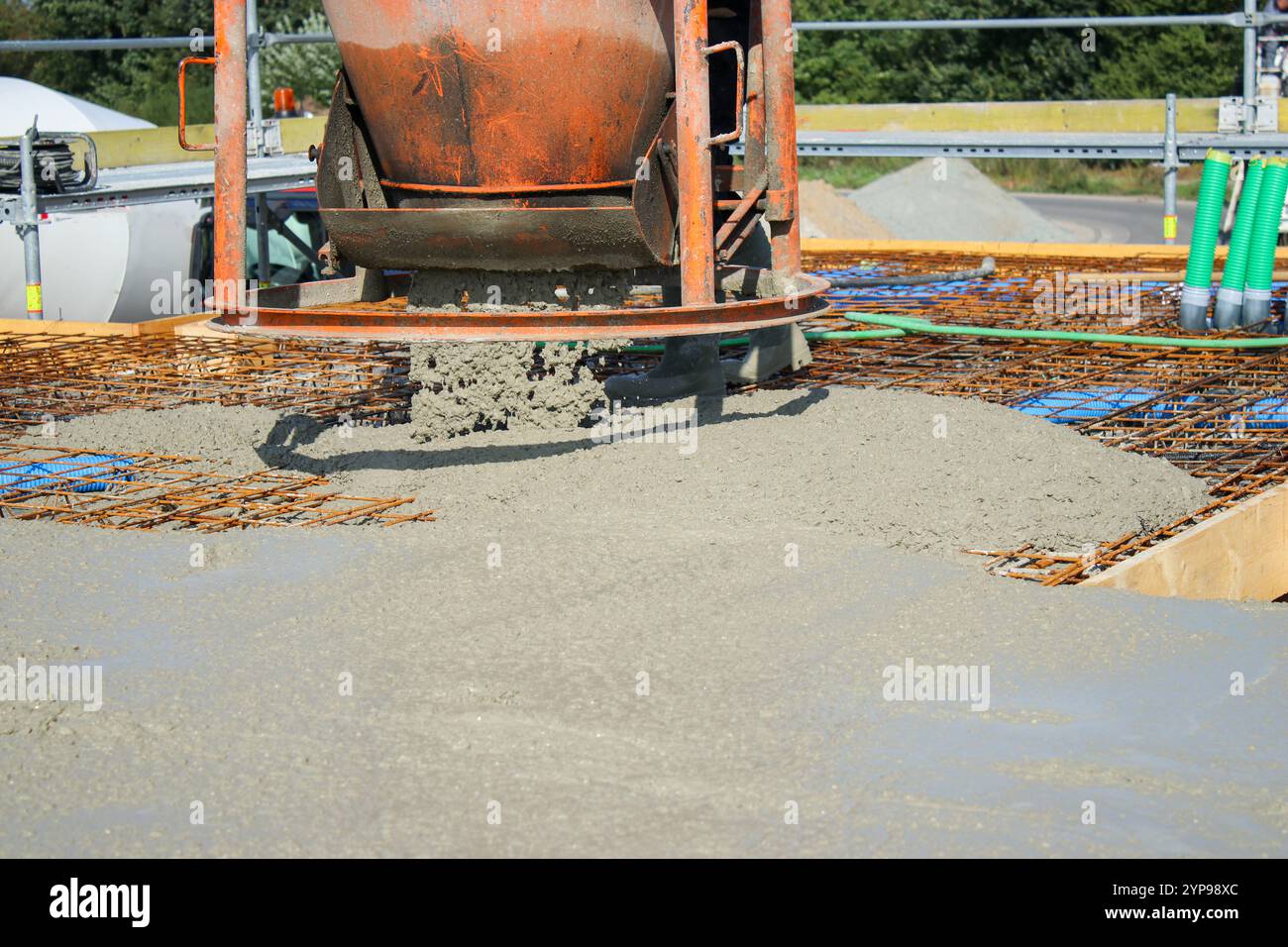 Workers filling the second floor ground with concrete, core and shell ...