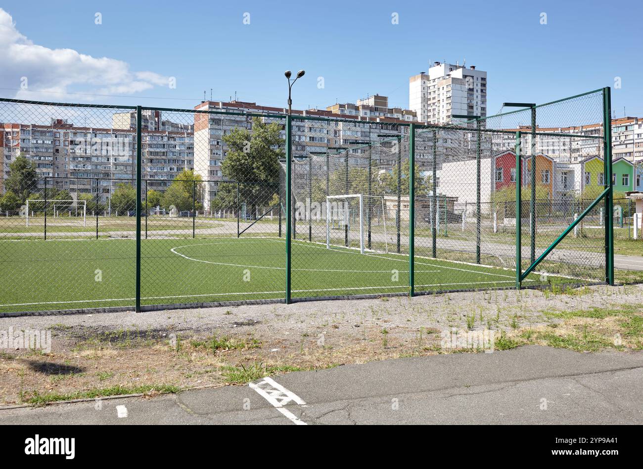 Lawn field for playing football behind the green fence mesh at school ...