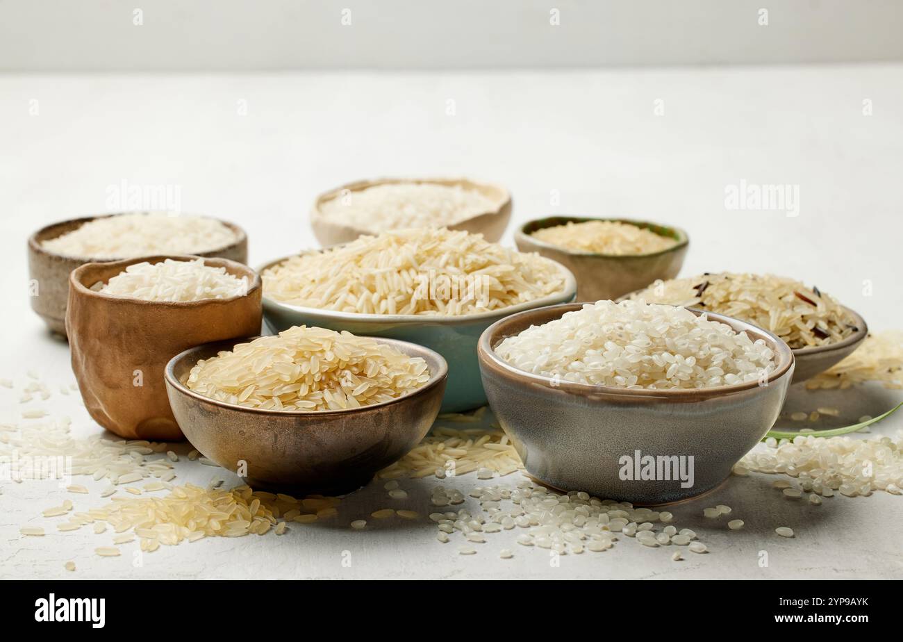 different types of rice on white kitchen table surface Stock Photo - Alamy